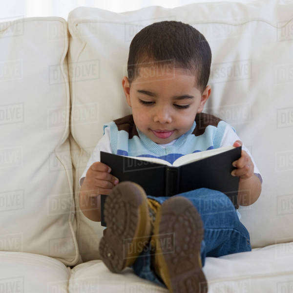 Young child looking at a book - Stock Photo - Dissolve