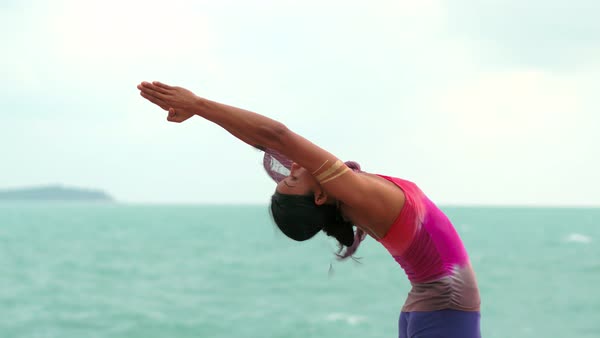 Asian Woman In Yoga Pose Surya Namaskar For Salutation To Sun On Beach
