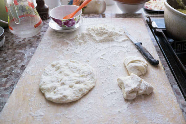 Dough on cutting board with flour - Stock Photo - Dissolve