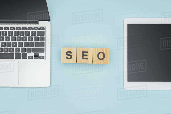 Top View Of Gadgets Near Wooden Blocks On Light Blue Background Stock top-view-of-gadgets-near-wooden-blocks-on-light-blue-background-stock