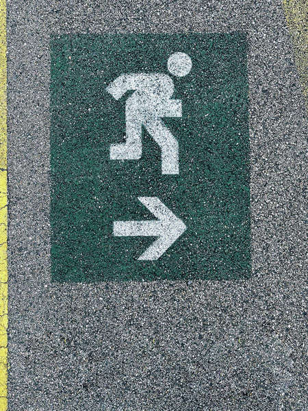 Overhead view of an escape sign on an asphalt road - Royalty-free Stock Photo | Dissolve
