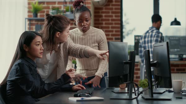 Mixed Team Of Programmers Brainstorming Ideas For New Code Library In Front Of Computer Screens 