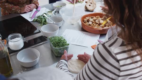 Female Teacher Demonstrating How To Prepare Dough In Kitchen Cookery ...
