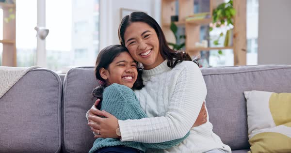 Hug, face and mother with girl child on a sofa with trust, care and happy in their home together ...