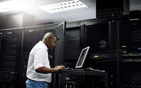 Server Room Black Man Or Coding On Computer For Programming Or Digital