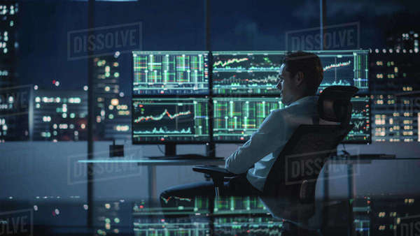 Financial Analyst Working on Computer with Multi-Monitor Workstation with Real-Time Stocks ...