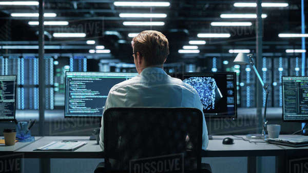 Professional IT Programer Working in Data Center on Desktop Computer with Two Displays, Doing ...