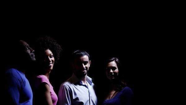 Group of people looking up against a black background - Stock Video ...