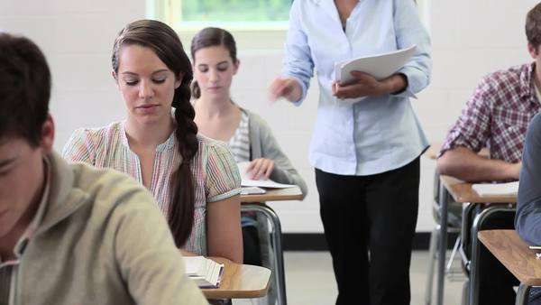 Teacher Handing Out Papers National Guard Deploys For New Emergency: