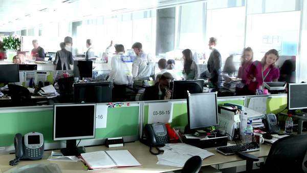 Timelapse of busy city office workers working together in large modern ...