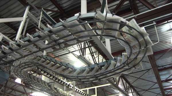Newspapers flow along an assembly line in a newspaper factory. - HD ...
