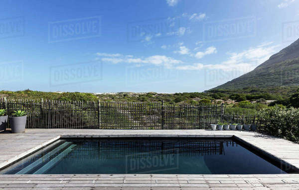 Tranquil dark swimming pool under sunny blue sky - Royalty-free Stock ...