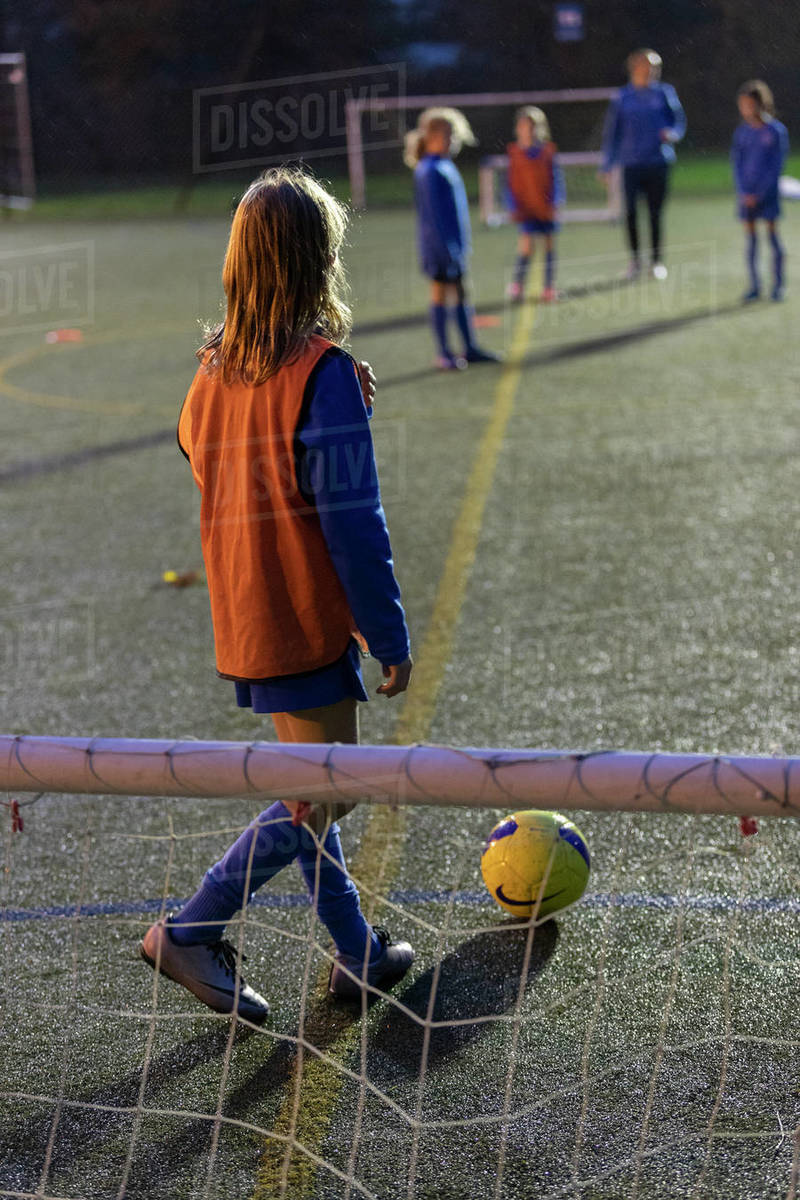 Girl soccer player practicing on field at night - Royalty-free Stock ...