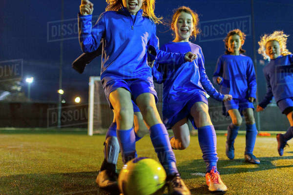 Girls soccer team practicing on field at night - Royalty-free Stock ...
