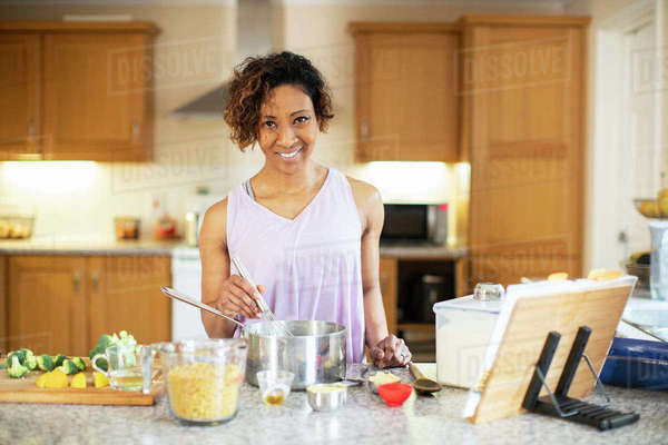 Portrait confident woman cooking in kitchen - Royalty-free Stock Photo ...