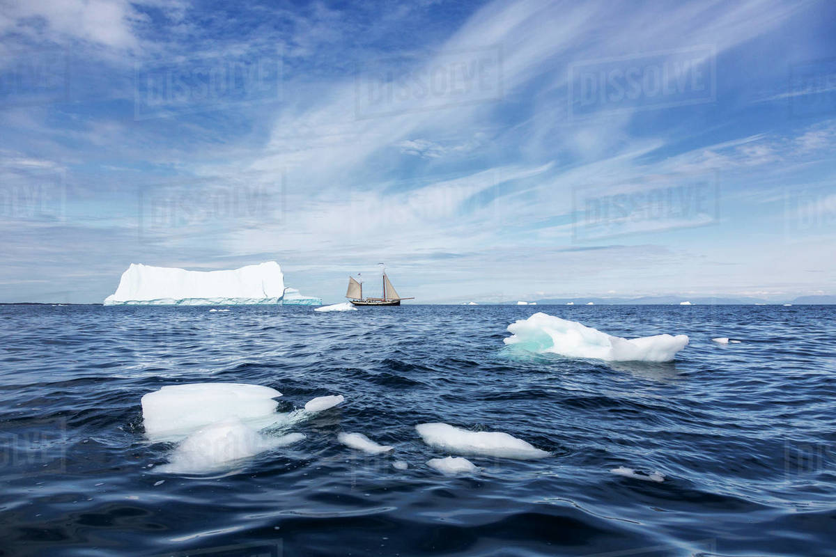 Sailboat among melting polar ice on sunny Atlantic Ocean Greenland ...
