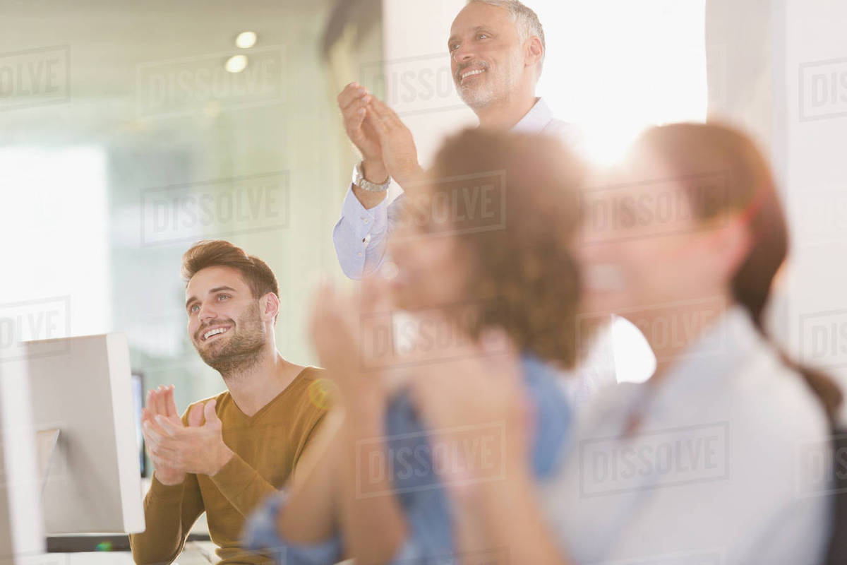 Business people clapping in office - Royalty-free Stock Photo | Dissolve