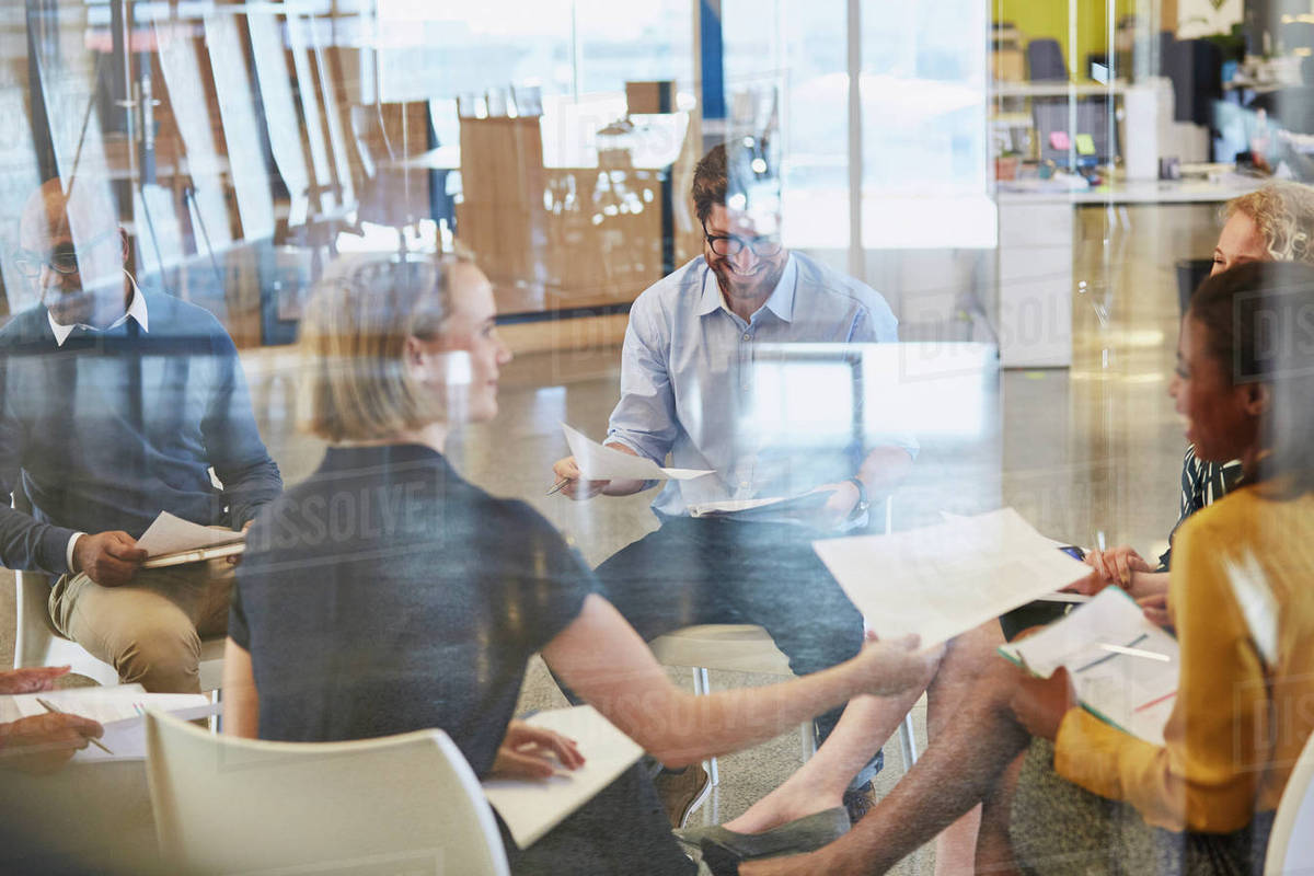 Business people reviewing paperwork in meeting - Royalty-free Stock ...