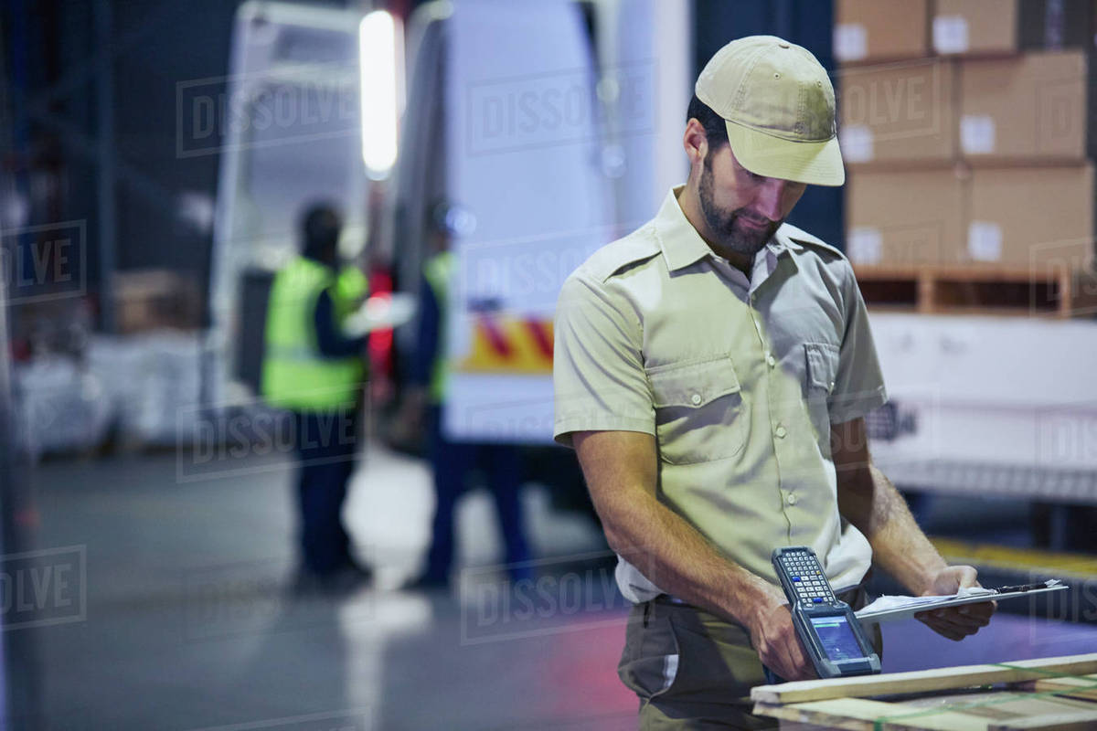 Truck driver worker scanning pallet at distribution warehouse loading ...