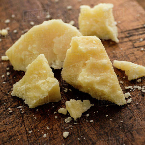 Parmesan cheese on wooden table - Royalty-free Stock Photo | Dissolve