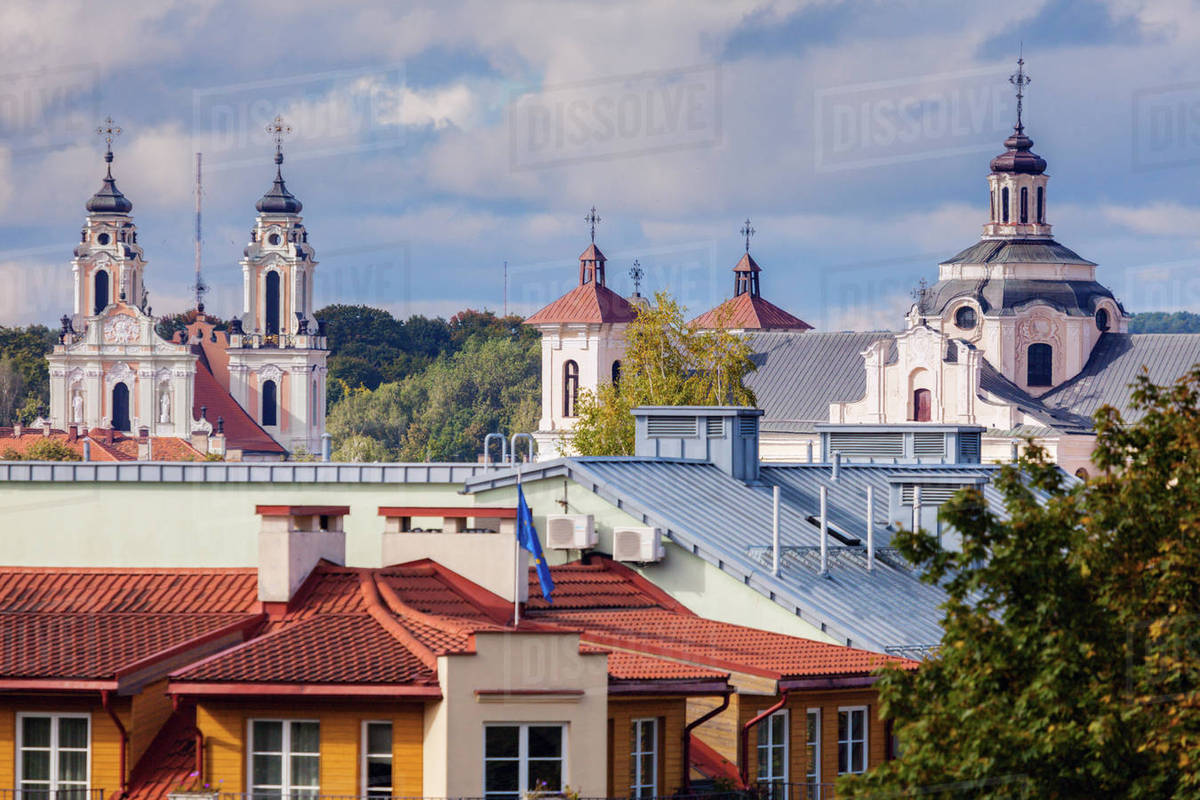 Lithuania, Vilnius, Residential building with churches in background ...
