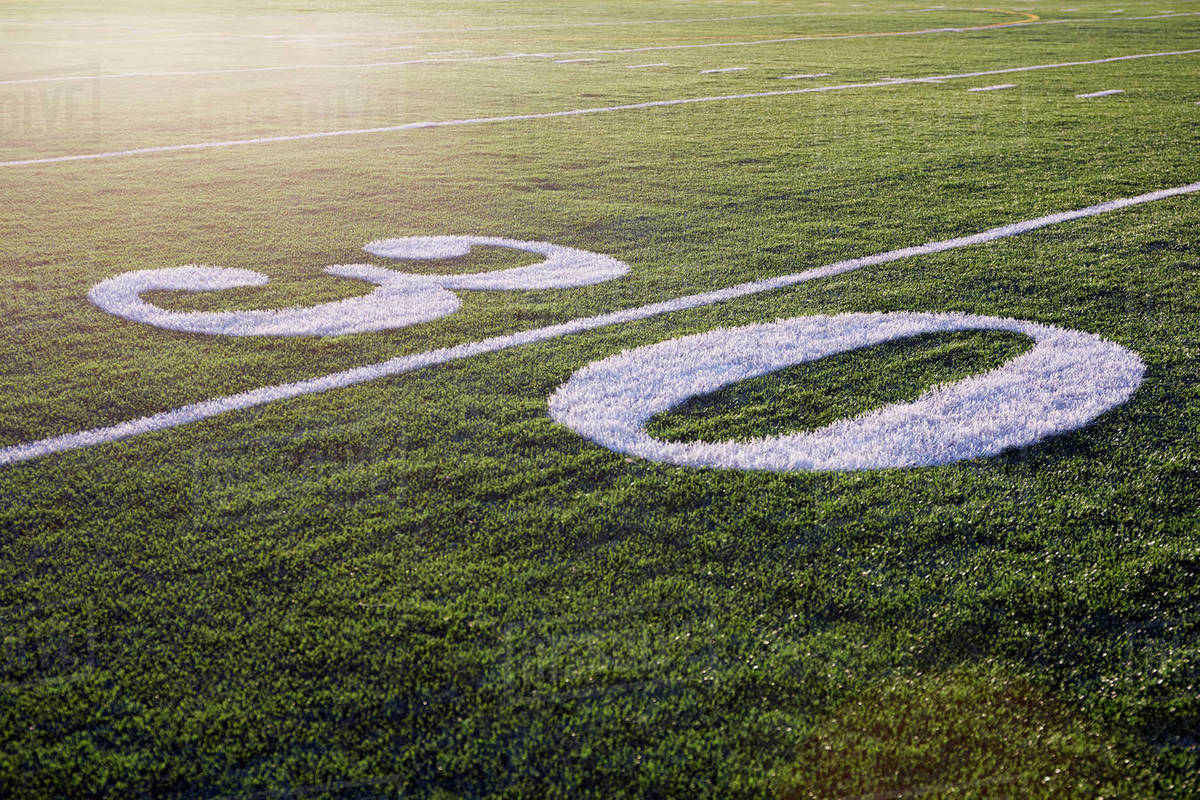 Thirty yard line on green playing field - Stock Photo - Dissolve