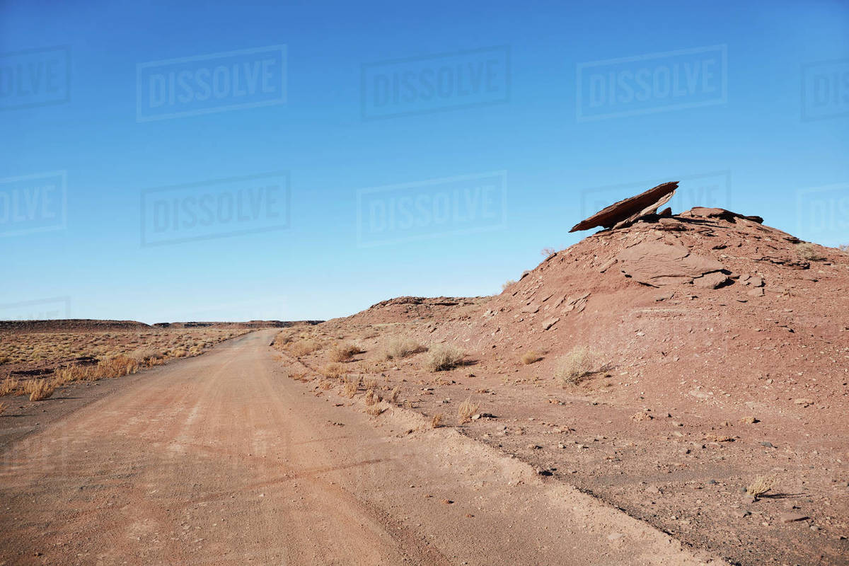 USA, Arizona, Empty road through desert landscape - Stock Photo - Dissolve