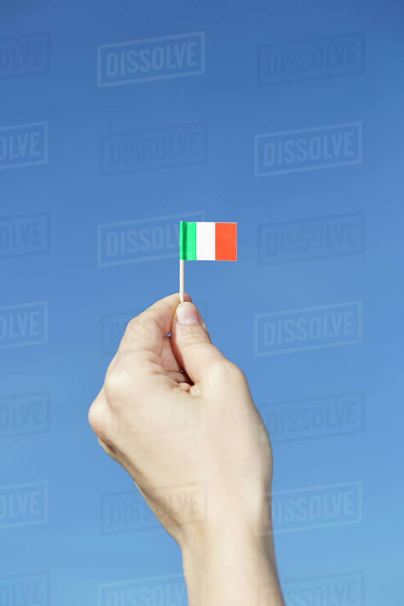 Woman holding Italian flag in hand - Royalty-free Stock Photo | Dissolve