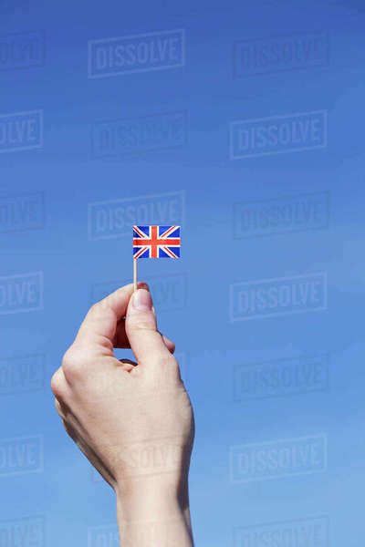 Woman holding British flag in hand - Royalty-free Stock Photo | Dissolve