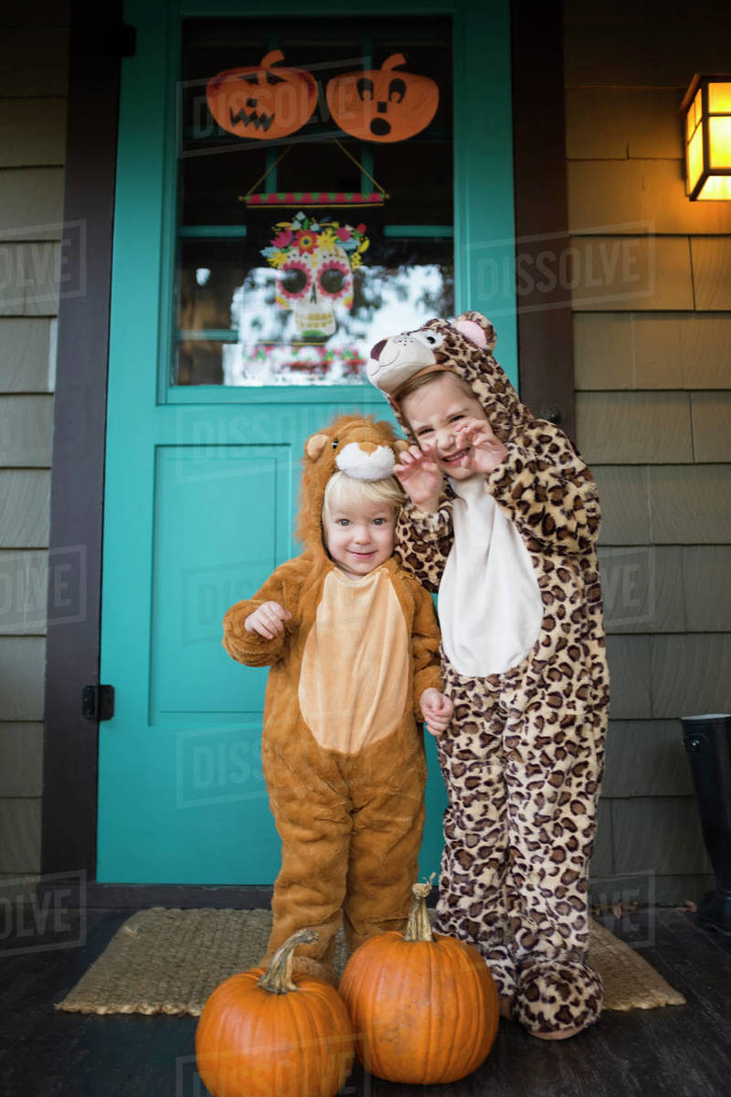 Two kids (2-3, 4-5) wearing Halloween costumes - Stock Photo - Dissolve