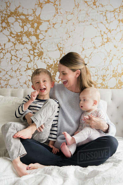 Portrait of happy mother of two children (18-23 months, 4-5) - Stock ...