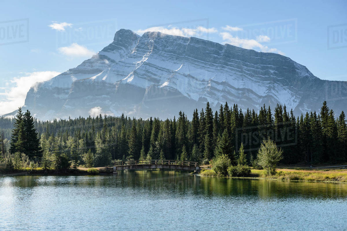 Canada, Alberta, Banff, Mountain peak reflecting in lake in Banff ...