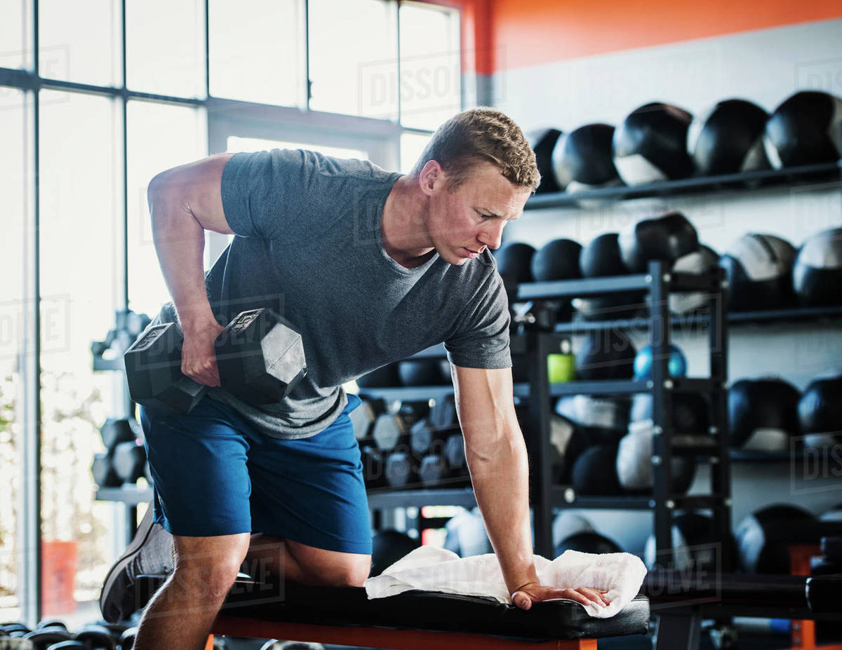 Mid adult man weight lifting - Royalty-free Stock Photo | Dissolve