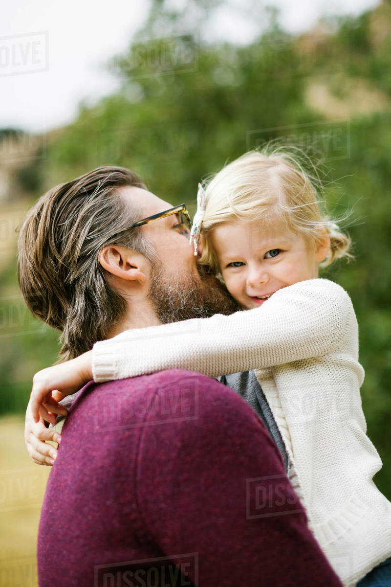 Man hugging his daughter - Stock Photo - Dissolve