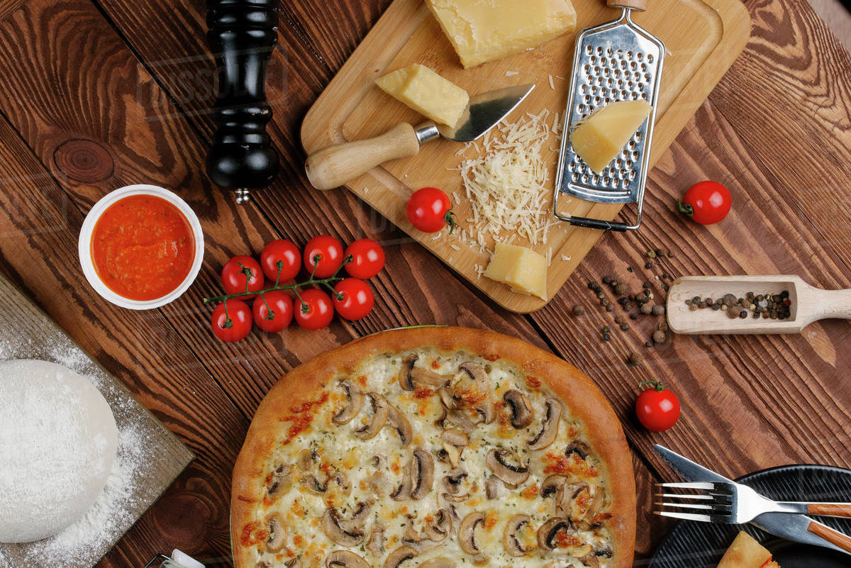 Mushroom pizza with ingredients - Stock Photo - Dissolve