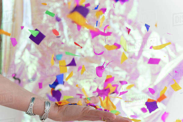 Woman's hand throwing confetti - Royalty-free Stock Photo | Dissolve