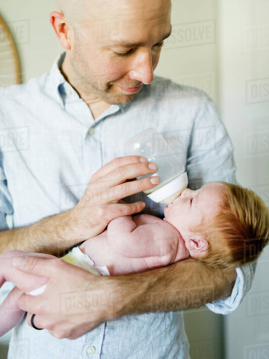 Man feeding his baby son - Royalty-free Stock Photo | Dissolve