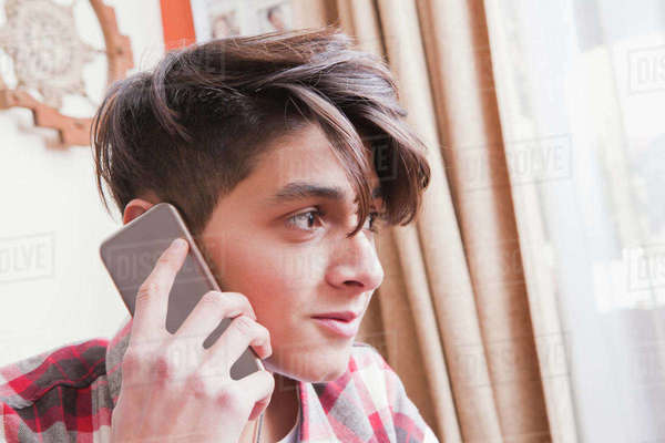 Portrait of teenage boy on phone call - Royalty-free Stock Photo | Dissolve