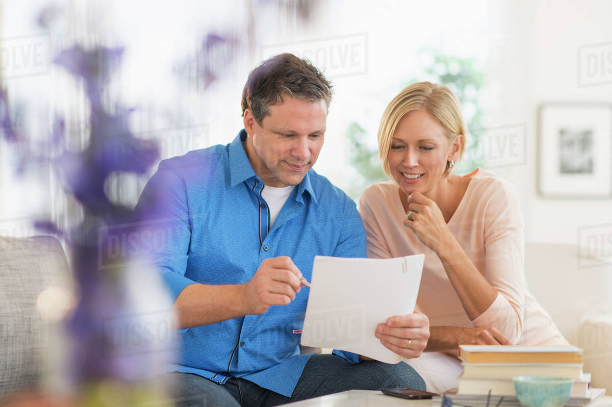 Couple doing paperwork at home - Royalty-free Stock Photo | Dissolve