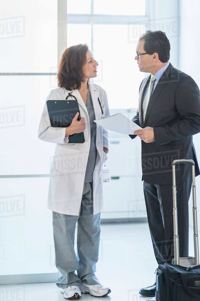 Pharmaceutical representative talking to female doctor - Royalty-free ...