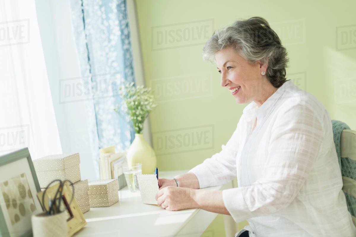 Mature woman writing letter - Stock Photo - Dissolve