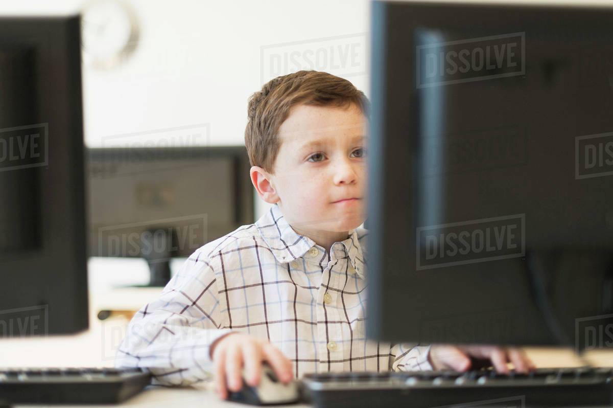 Boy (6-7) using computer - Royalty-free Stock Photo | Dissolve