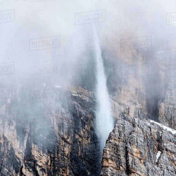 Snow falling down cliff in Dolomites, Italy - Royalty-free Stock Photo ...