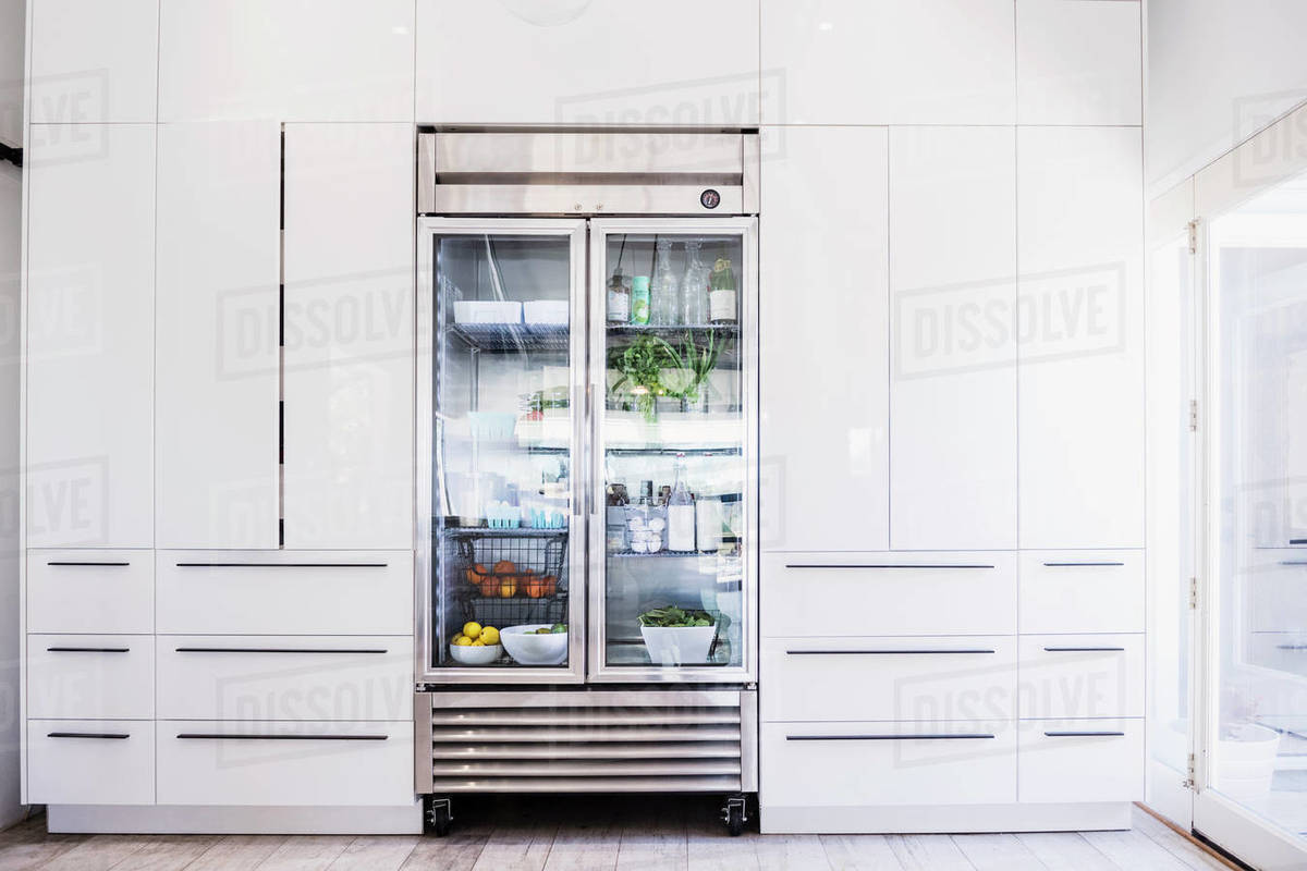 Glass refrigerator in modern kitchen - Royalty-free Stock Photo | Dissolve