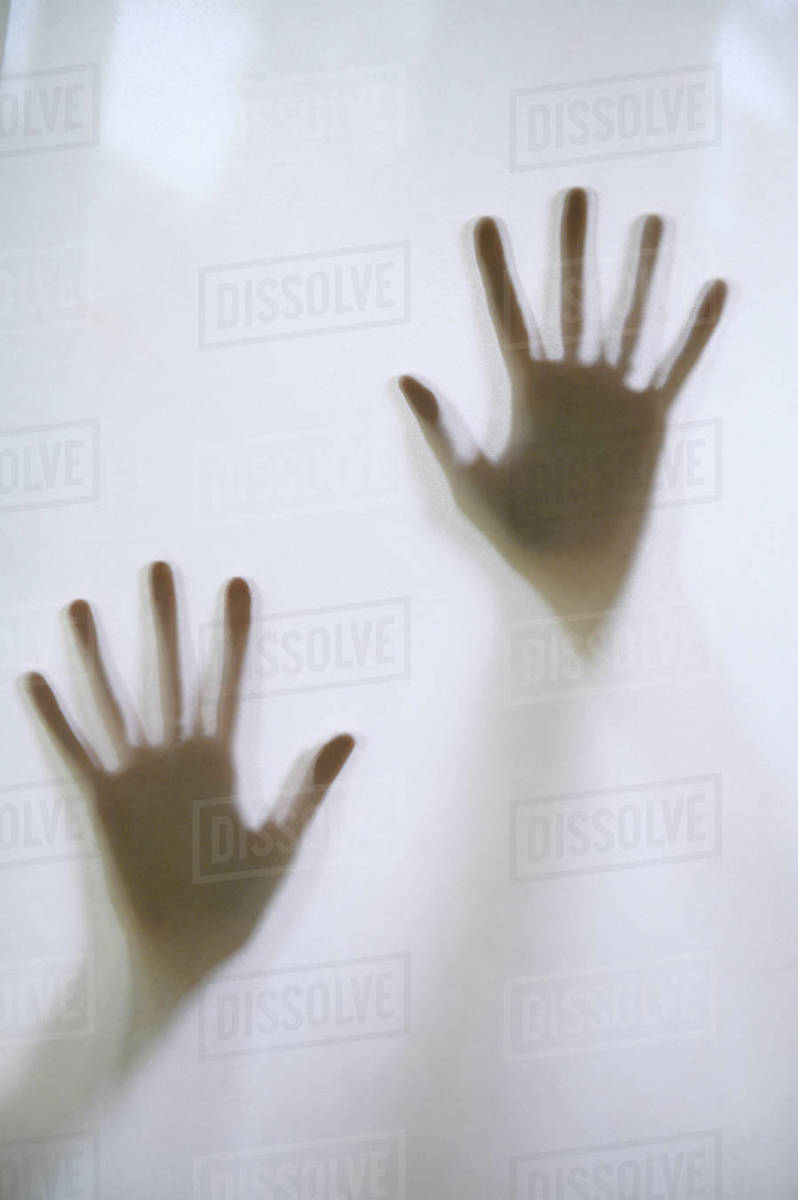 Woman's hands touching frosted glass - Royalty-free Stock Photo | Dissolve