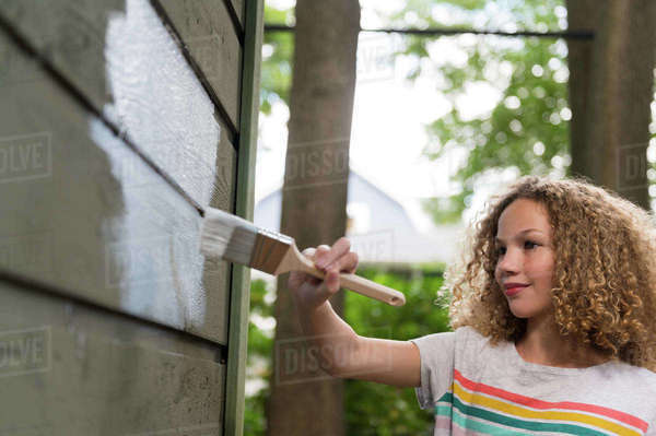 Girl painting house - Royalty-free Stock Photo | Dissolve