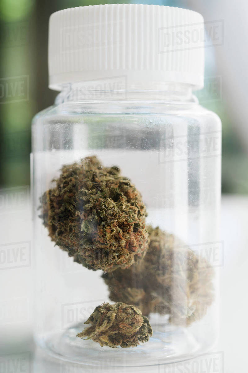 Medical marijuana in bottle - Stock Photo - Dissolve