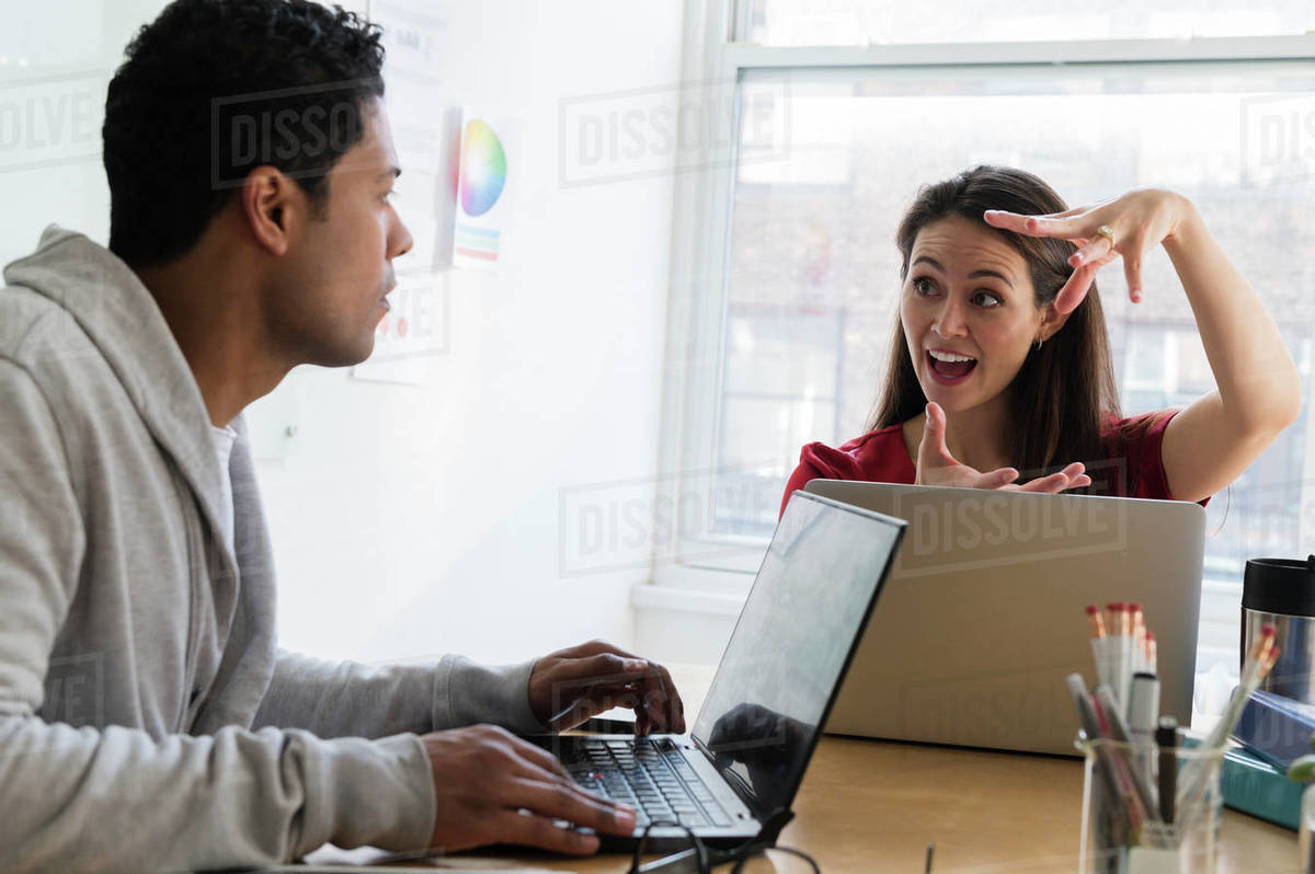 Businesswoman explaining something to coworker - Stock Photo - Dissolve