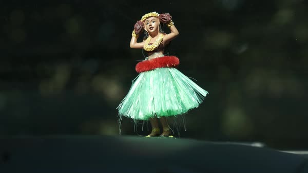 Hula dancer ornament on dashboard of moving car - Stock Video Footage ...