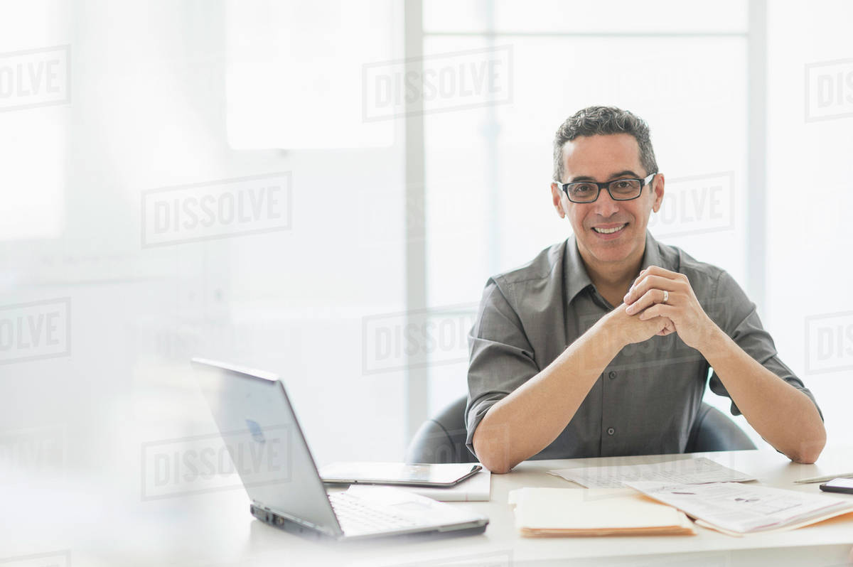Portrait of man at desk in office - Royalty-free Stock Photo | Dissolve